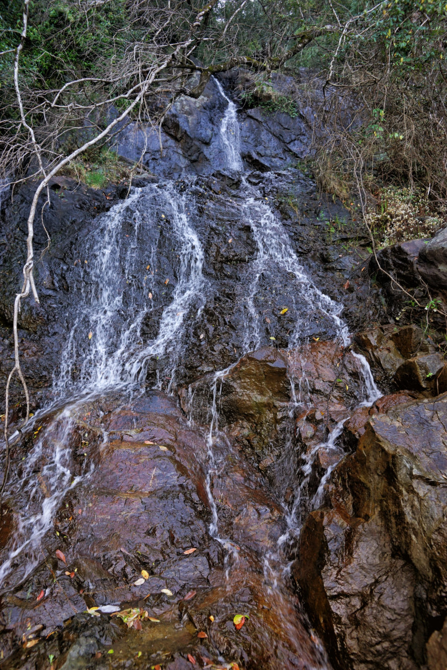 little waterfall with water running over rocks background image | Free ...