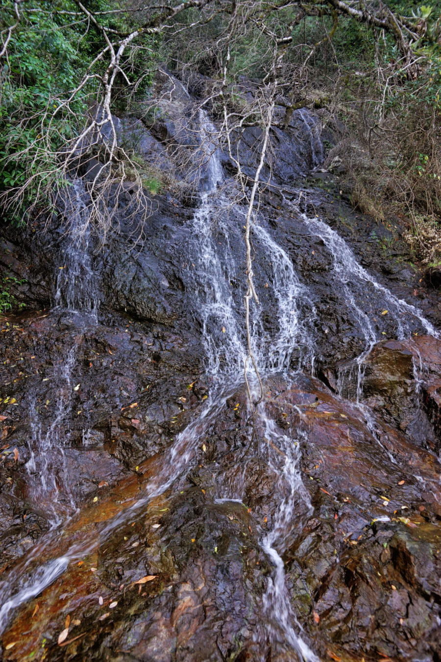 background photo of a little waterfall with water running over rocks ...