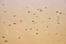 Three photos of small stones and beach sand